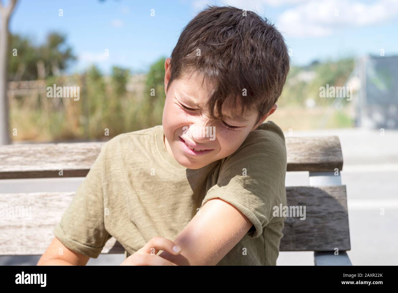 Full body of asian child injured at elbow. Sad boy groaning with a ...