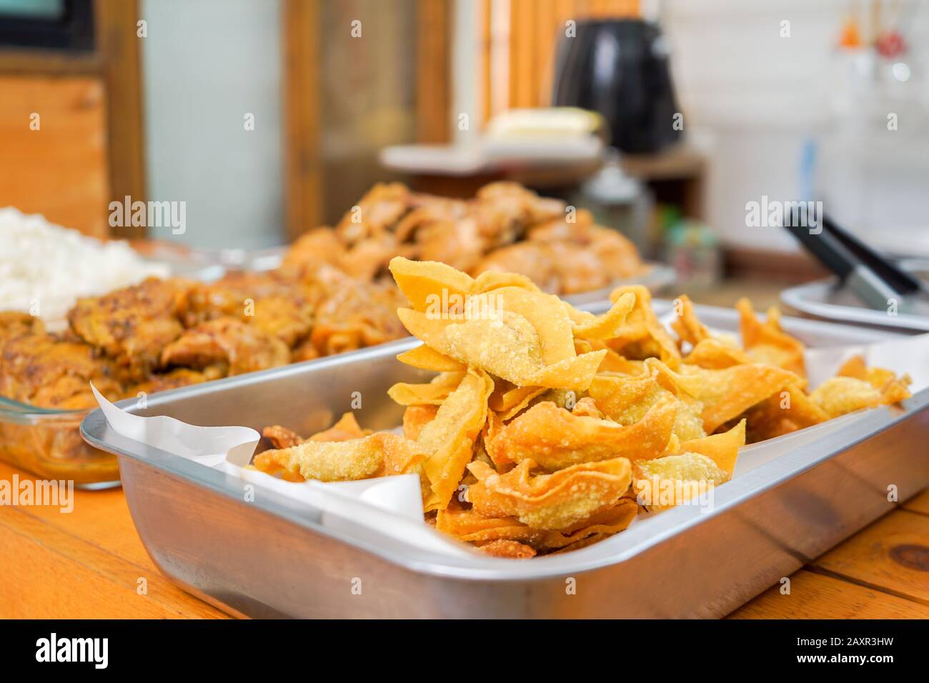 a lot of homemade Thai deep fried wonton in aluminum plate prepare for ...