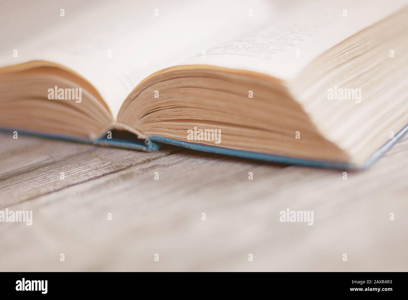 Open old-fashioned paper book backlit with daylight Stock Photo - Alamy