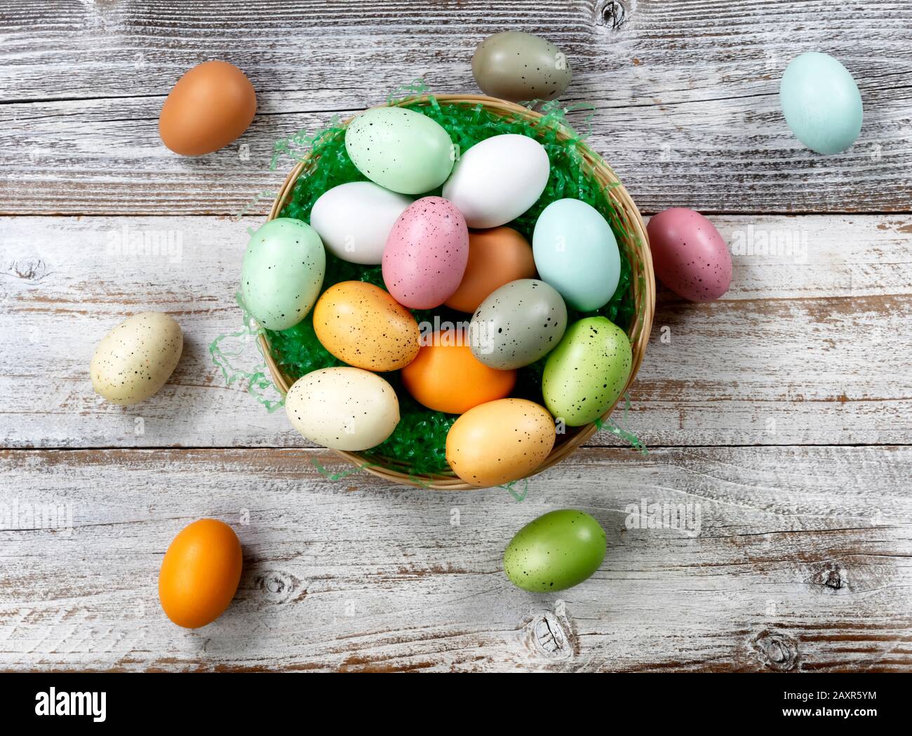 Happy Easter concept with basket filled of colorful eggs on white ...