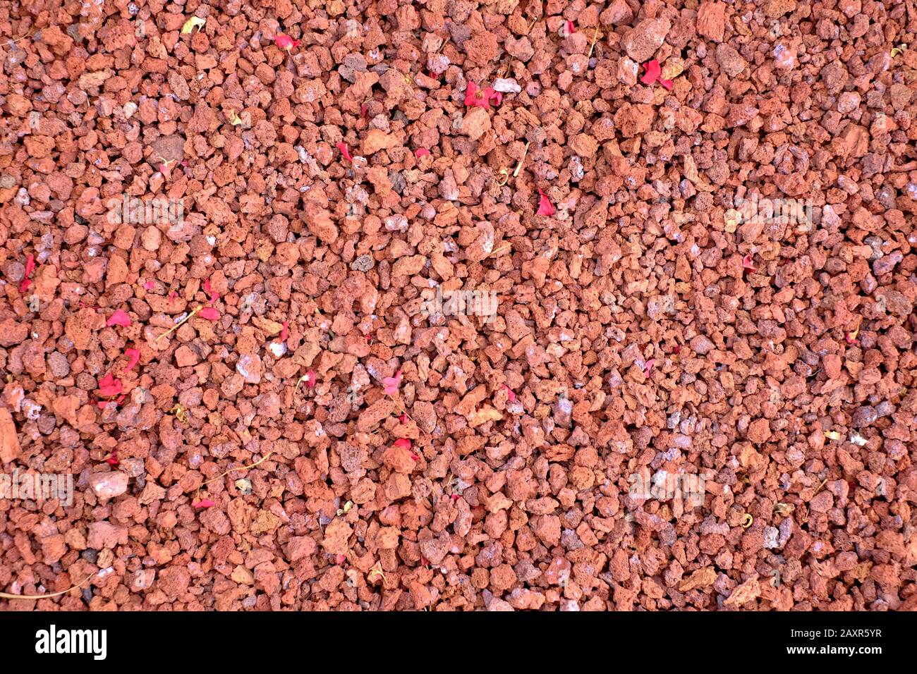 Red and orange volcanic gravel material Stock Photo - Alamy