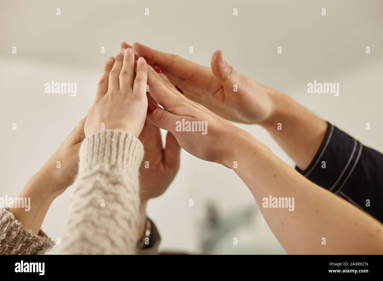 a success and winning concept - happy business team giving high five in ...