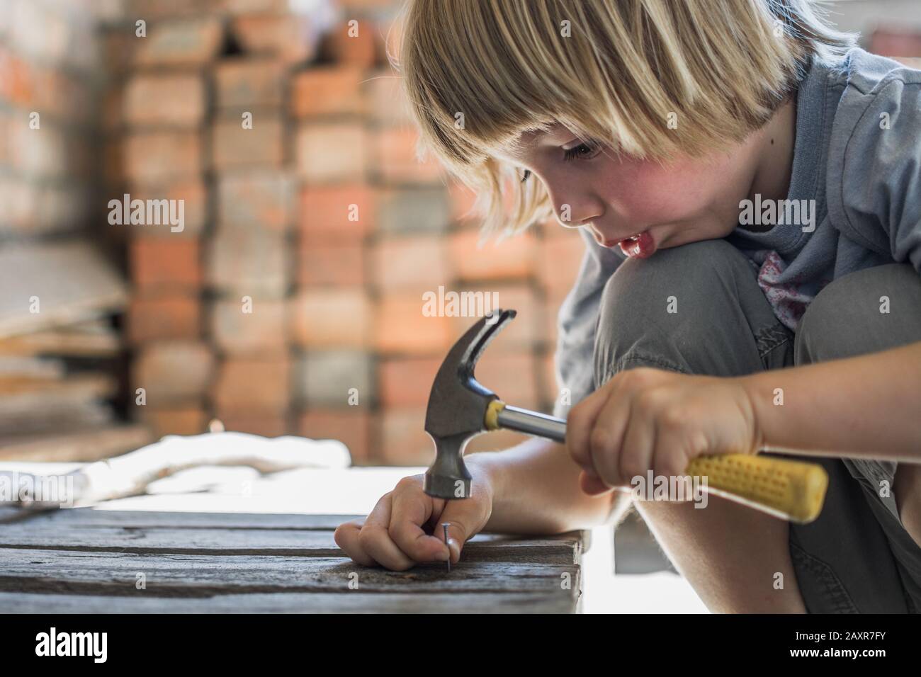 Boy playing with hammer hi-res stock photography and images - Alamy