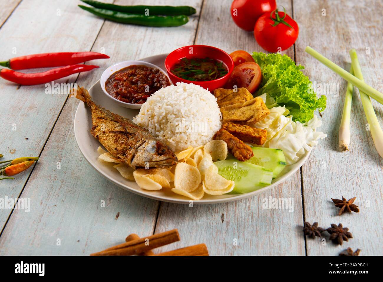 traditional fried mackerel fish with rice , sambal , vegables and mixed ...