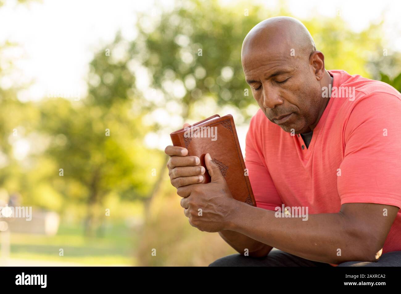 Smiling man holding bible hi-res stock photography and images - Alamy