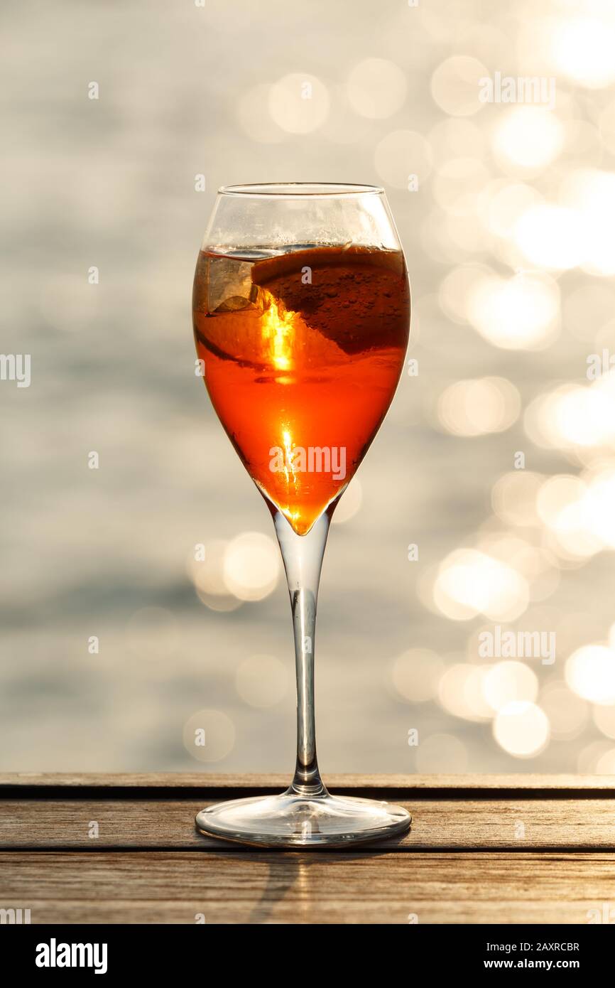 Aperol spritz at a wooden pier at sunset. Luxury resort vacation ...
