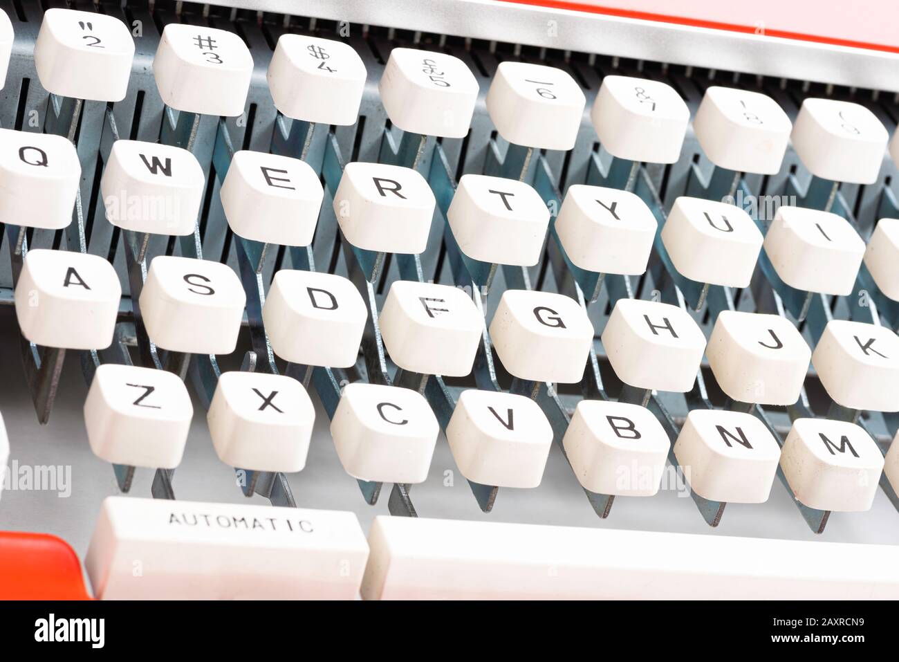 A studio shot of a retro-style portable manual typewriter with ivory ...