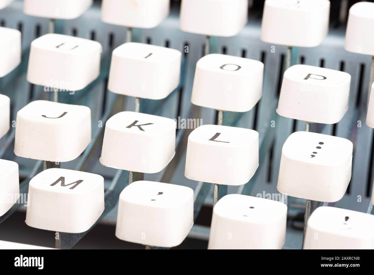 A studio shot of a retro-style portable manual typewriter with ivory ...