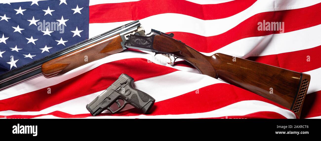 Pistol and over under shotgun in front of the American flag, panoramic ...