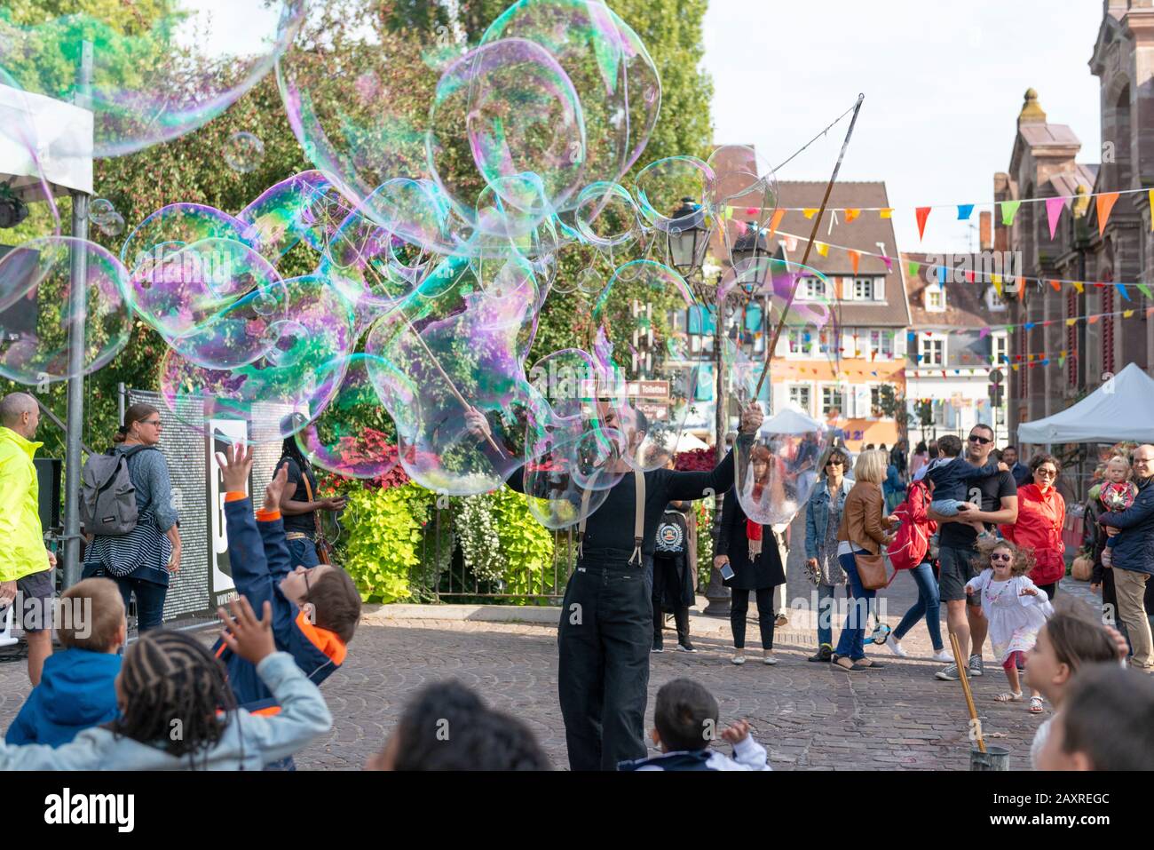 France, Alsace, Colmar, street artist at the market hall Stock Photo ...