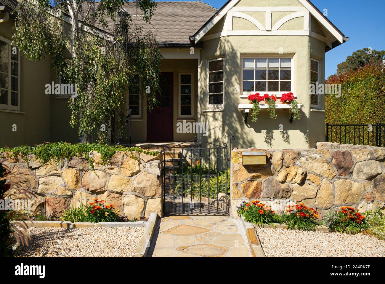 California home with entry iron gate and sandstone garden wall Stock ...