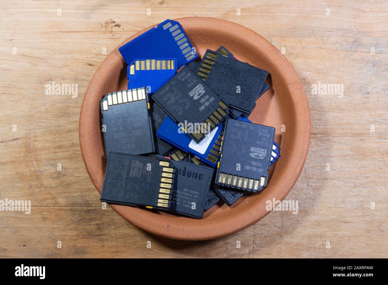 Used SD-memory cards in red clay plate Stock Photo - Alamy