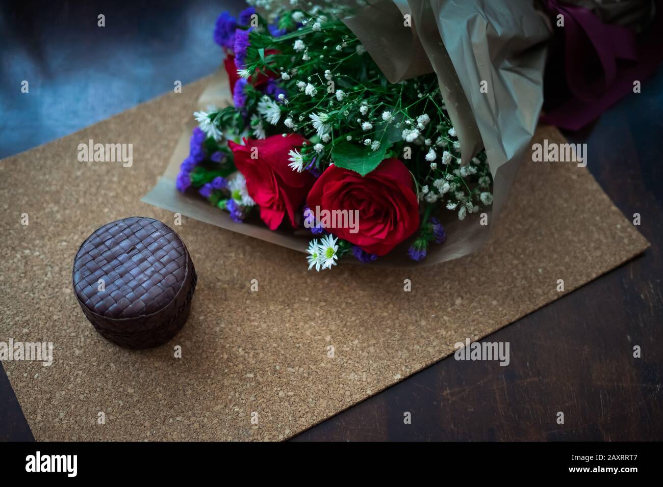 bouquet of roses arrangements of flowers in a paper wrapper on wooden ...