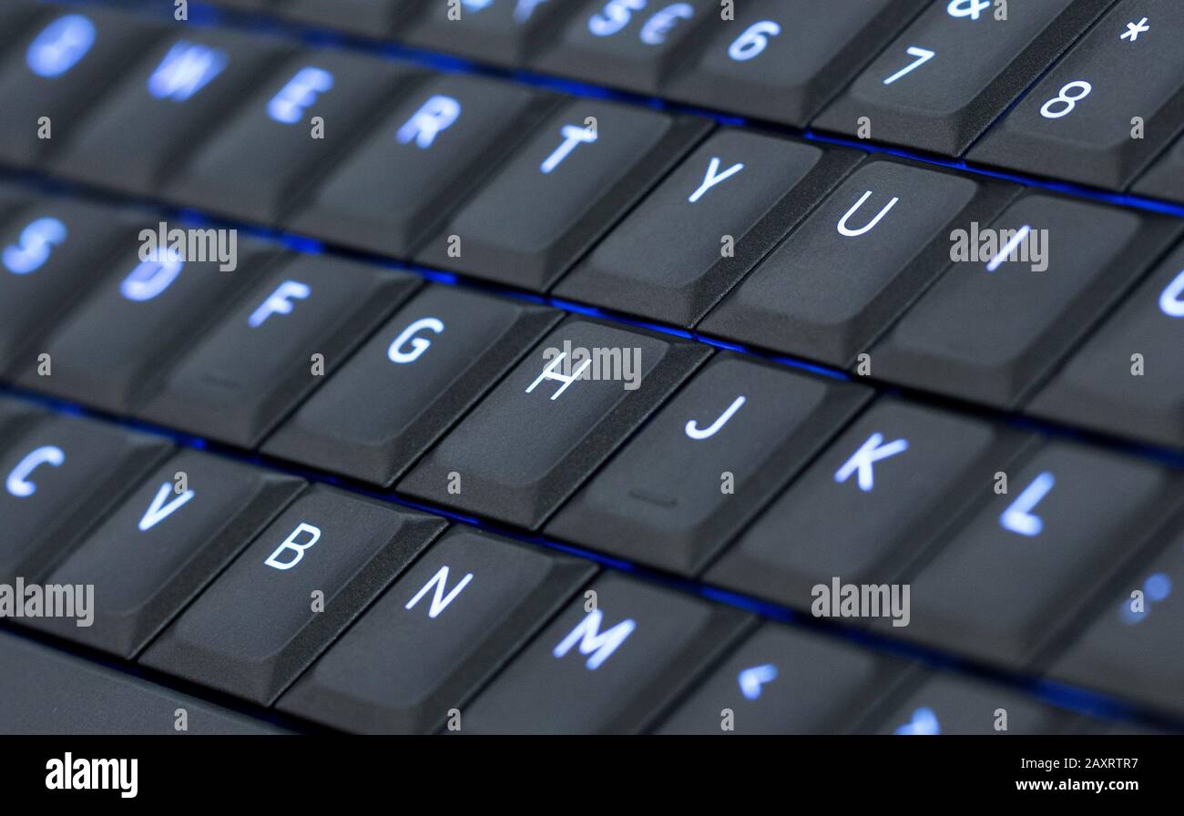 Close up led backlit computer laptop keyboard, blue Stock Photo - Alamy