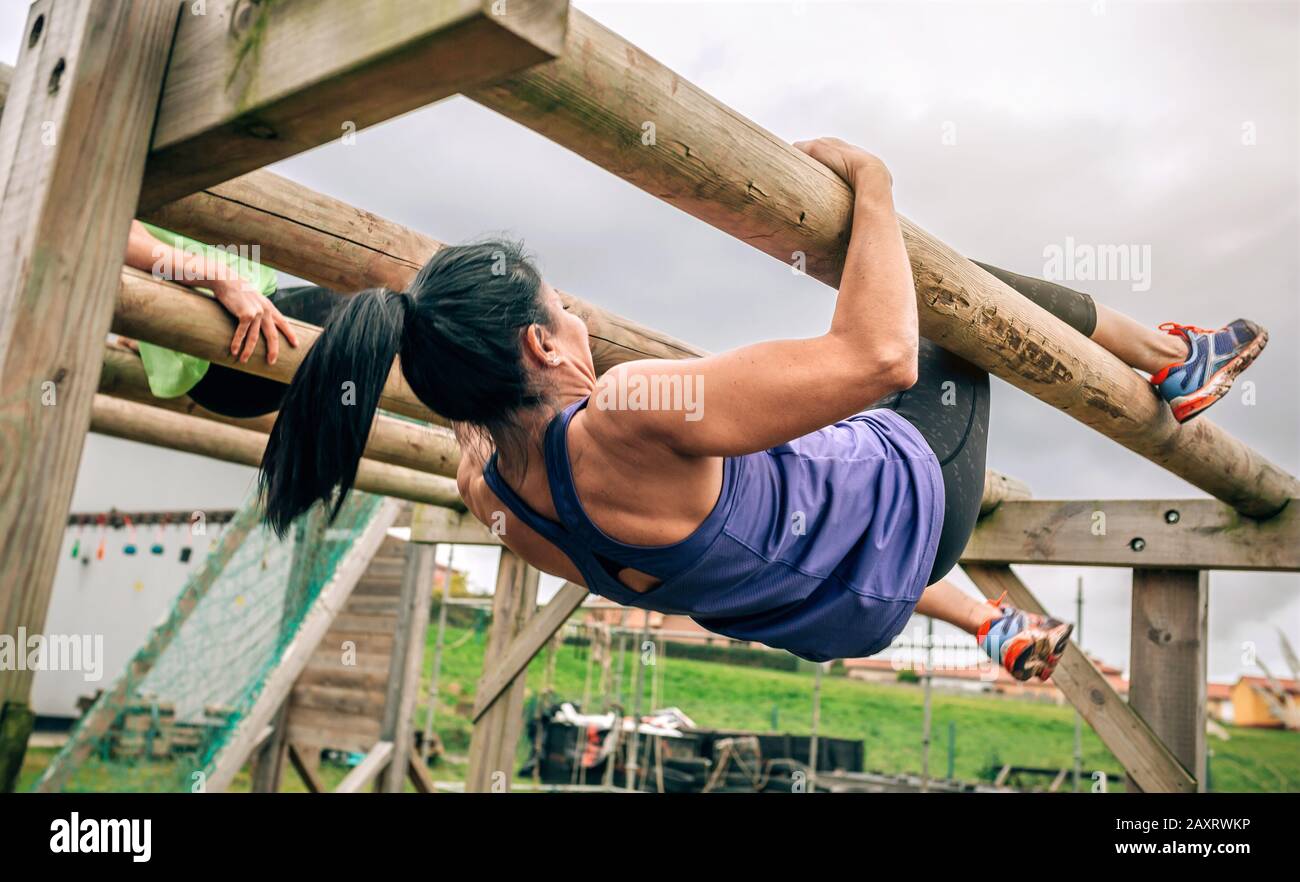 Participant in a obstacle course doing weaver Stock Photo - Alamy