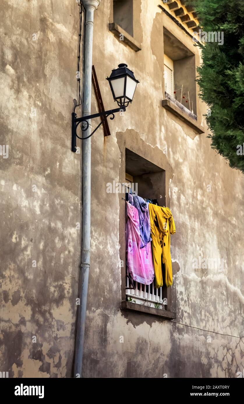 Clothes on drying by the window in Magalas Stock Photo - Alamy