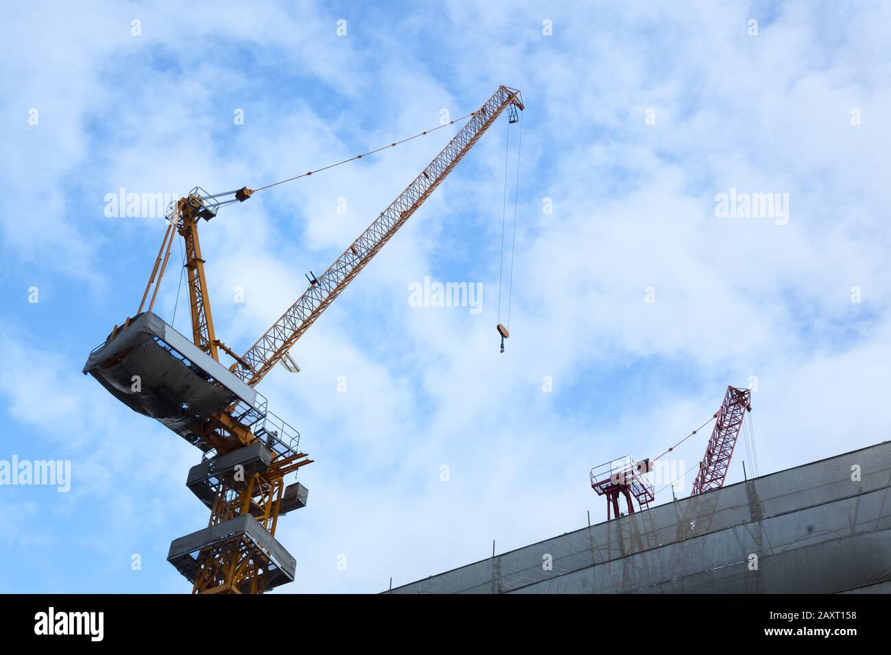 Construction tower cranes building on empty blue sky background ...