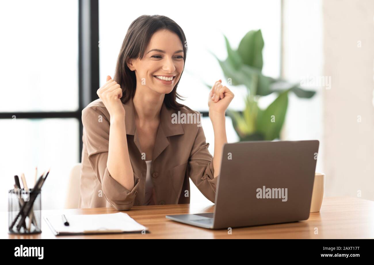 Excited manager celebrating her victory at work Stock Photo - Alamy
