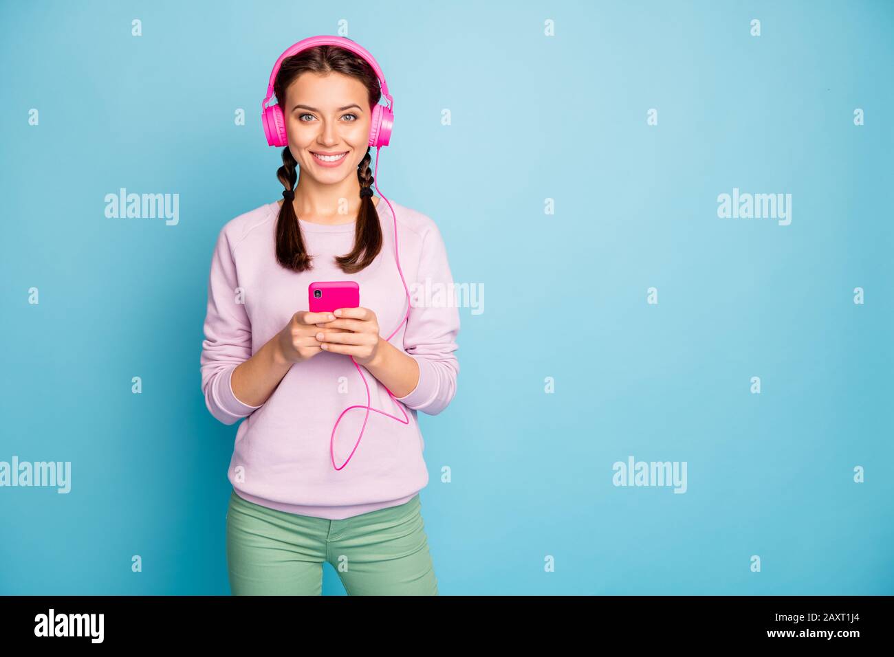 Photo of amazing pretty lady holding telephone cool bright earphones on ...