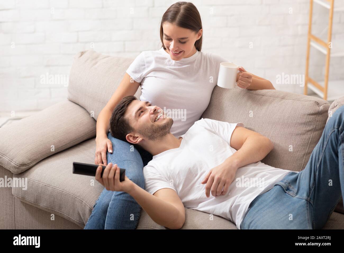 Couple In Love Watching TV Enjoying Day-Off At Home Stock Photo - Alamy