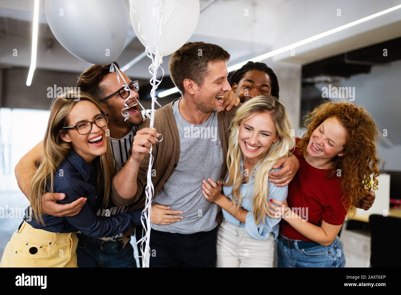 Happy business people celebrating success at company Stock Photo - Alamy