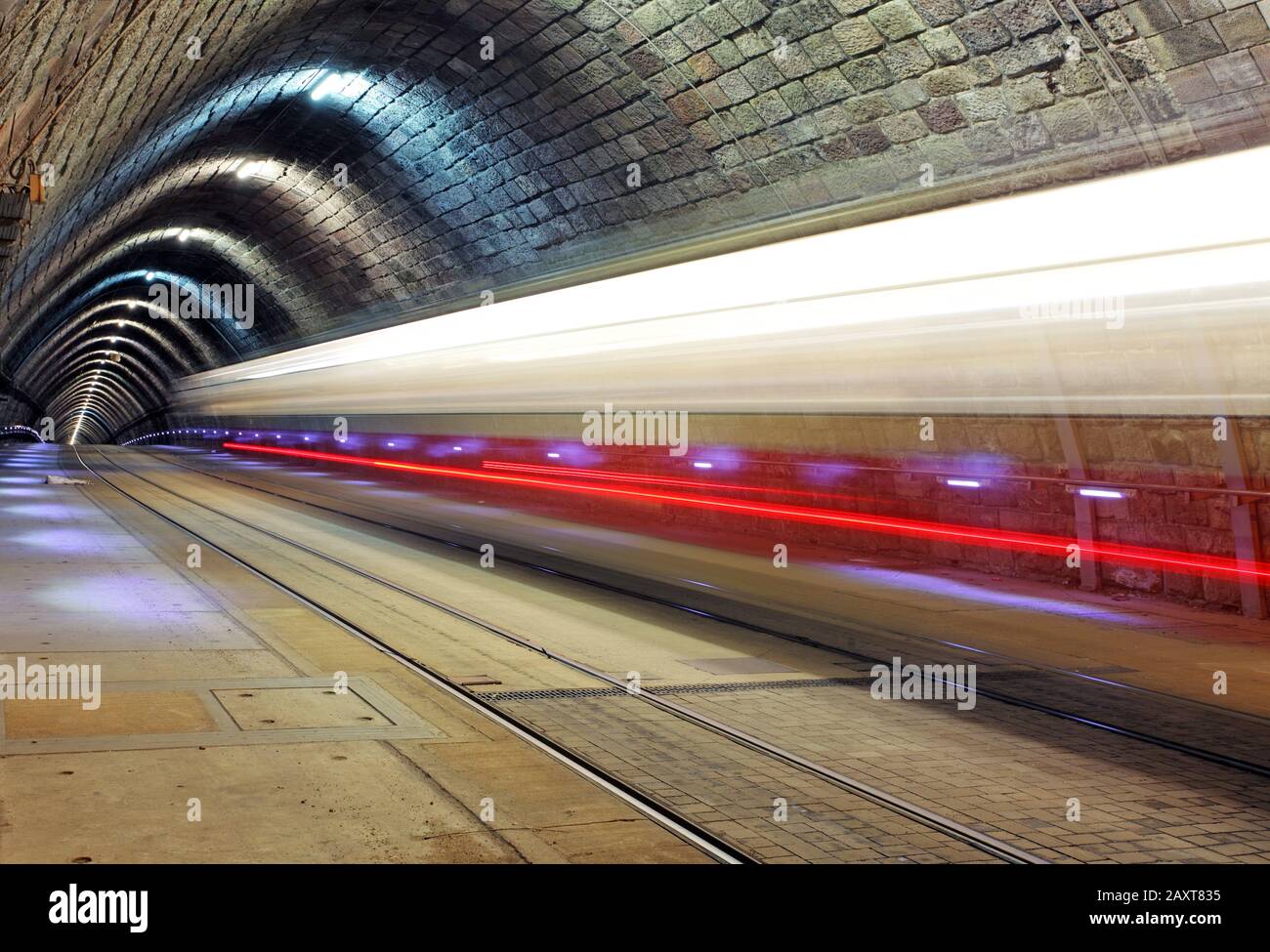 Train disappearing into a tunnel Stock Photo - Alamy