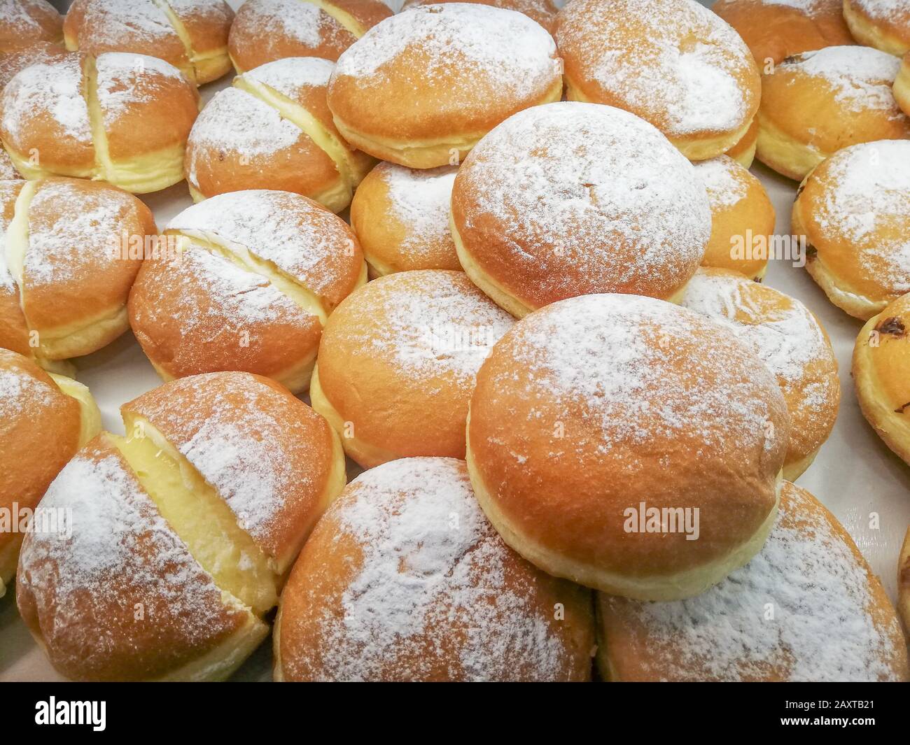 fresh donuts filled with cream and without in a bakery on the shelf ...