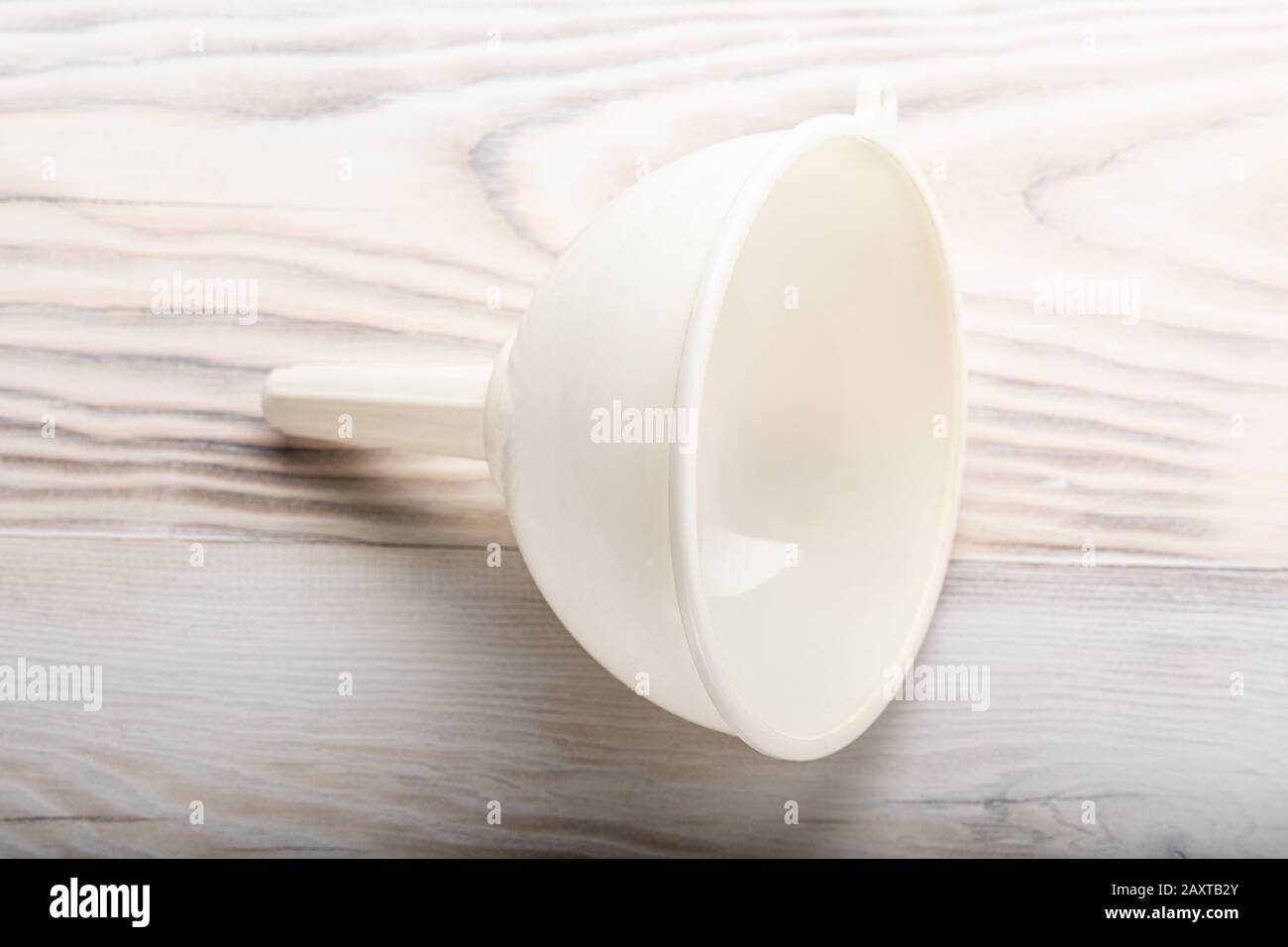 White plastic funnel liquid on wood kitchen table background Stock ...