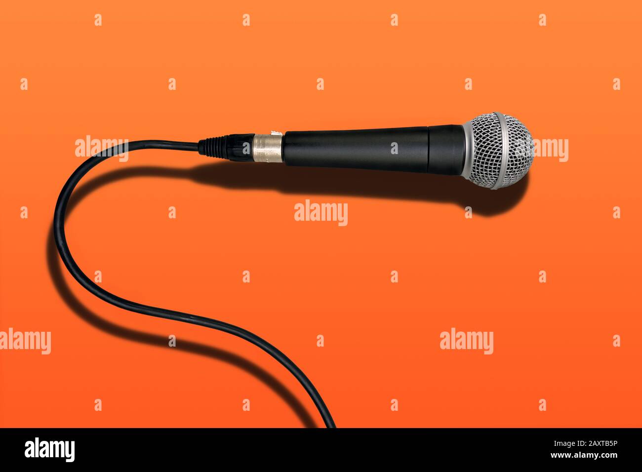 wired singer black and grey microphone on red lava color background ...
