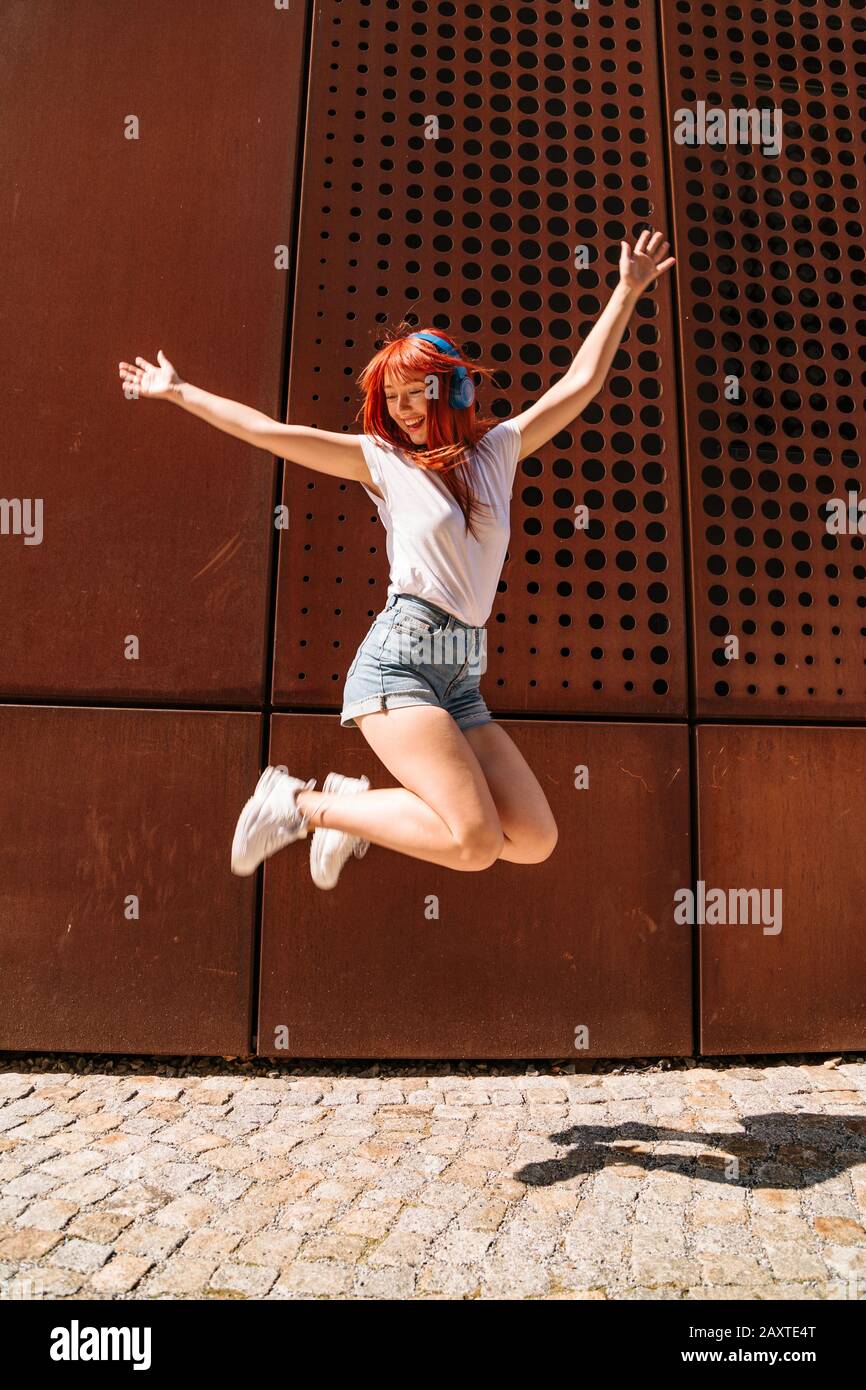 Young girl dancing on street and jumping high up Stock Photo - Alamy