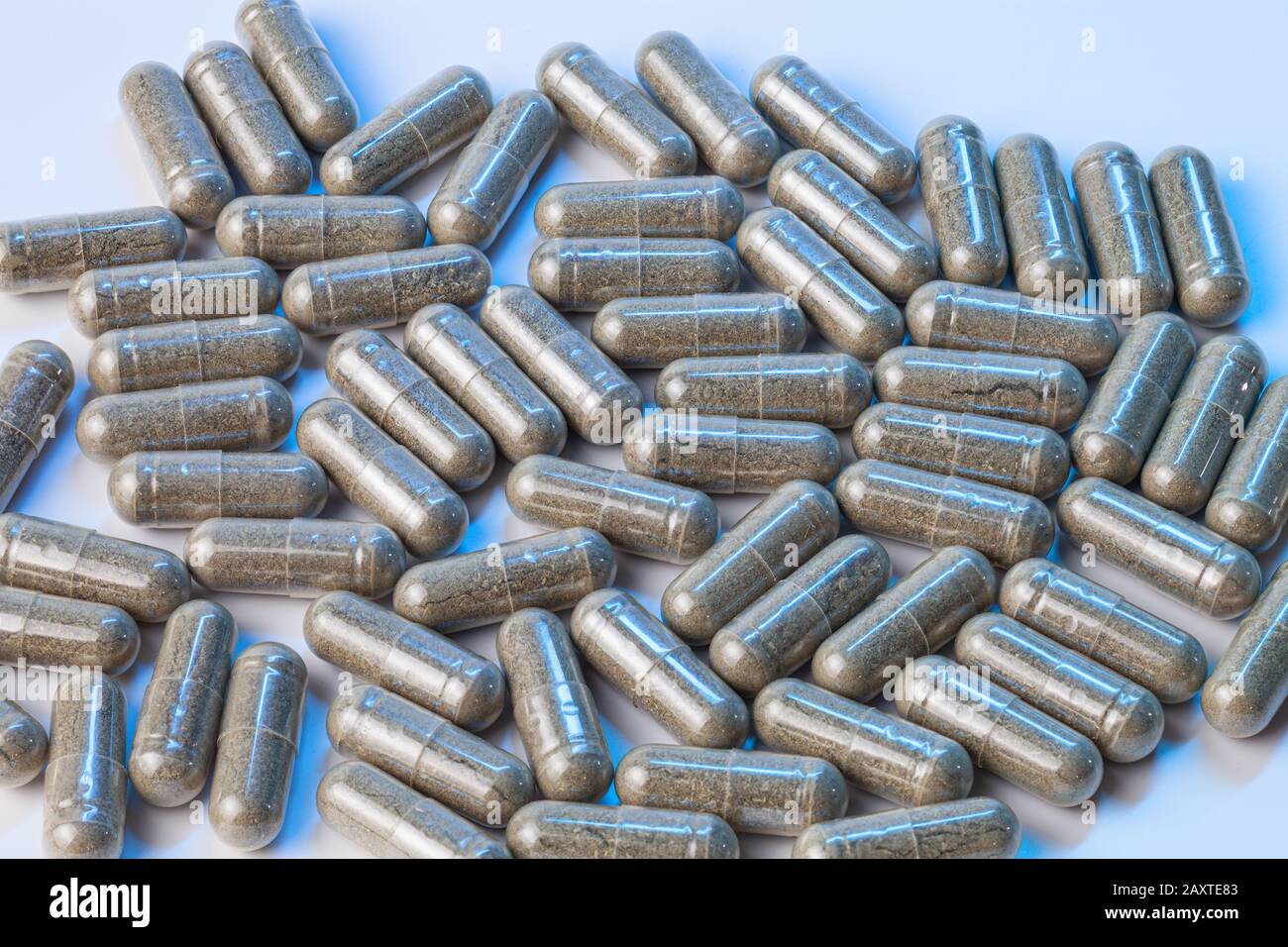 brown capsules pills on white background with blue lights Stock Photo ...