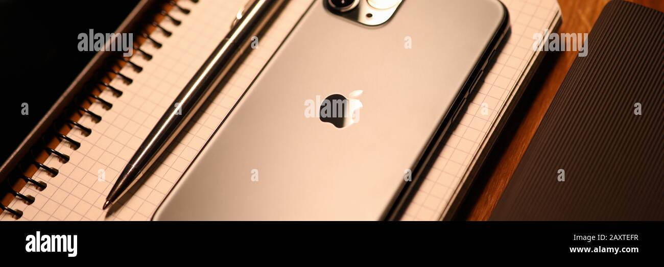 Apple iphone pro with silver pen on notebook Stock Photo - Alamy