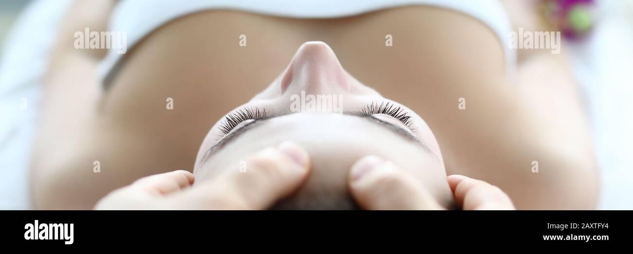 Male masseur hand make face massage young caucasian Stock Photo - Alamy