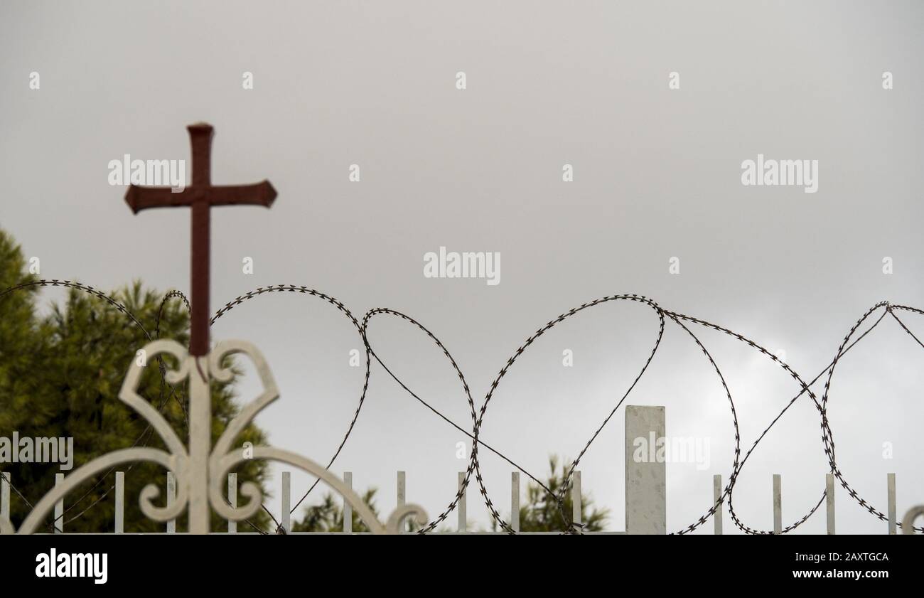 Jerusalem, Israel - cross and a chain fence and barbed wire Stock Photo ...