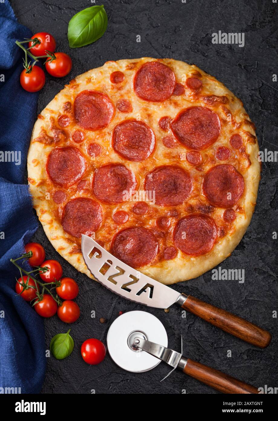 Fresh round baked Pepperoni italian pizza with wheel cutter and knife ...