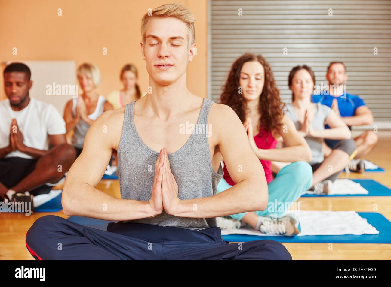 Relaxed group meditating in the yoga class in the fitness center Stock ...