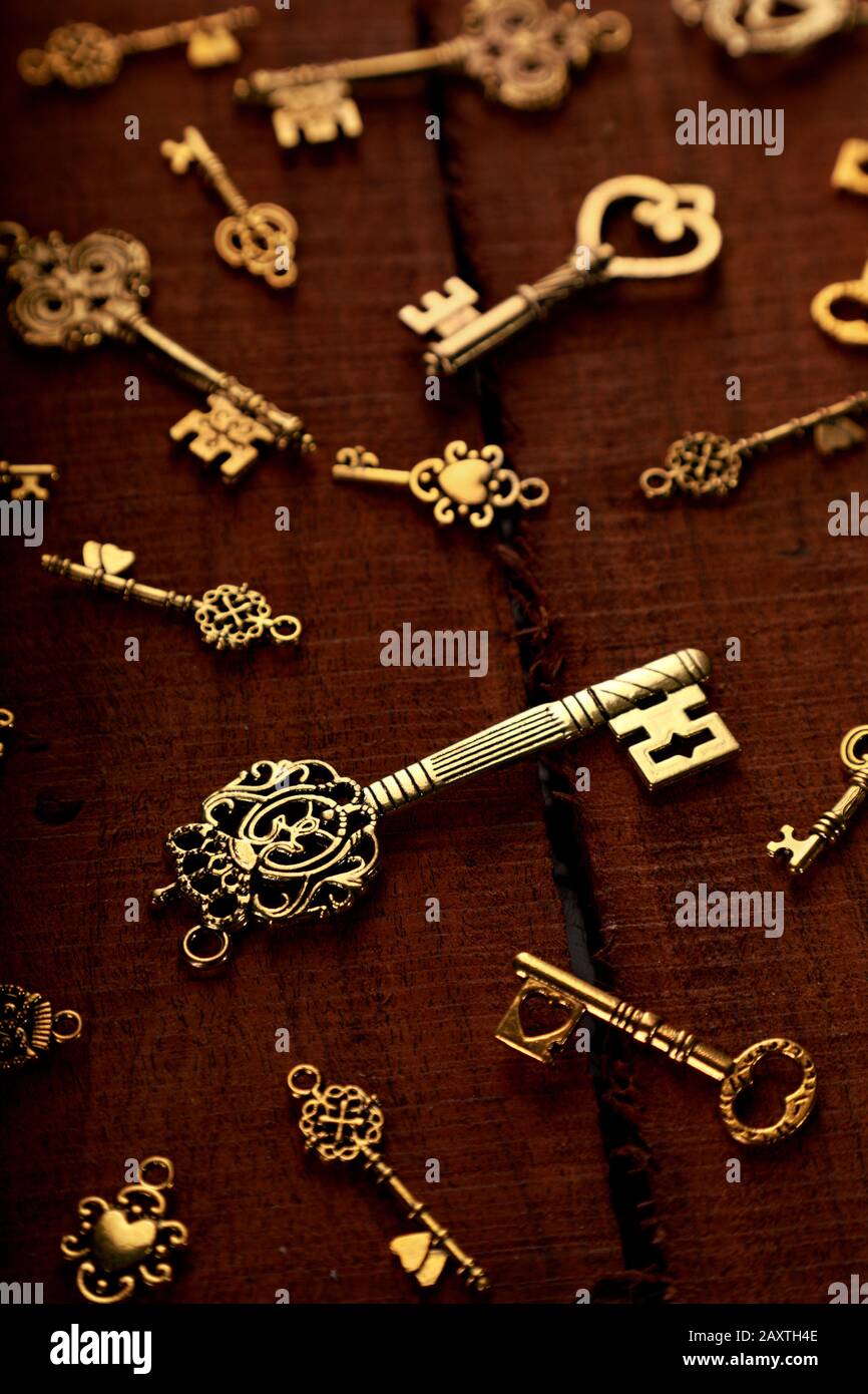 Group of Golden Antique Keys on an old Wood Background Stock Photo - Alamy