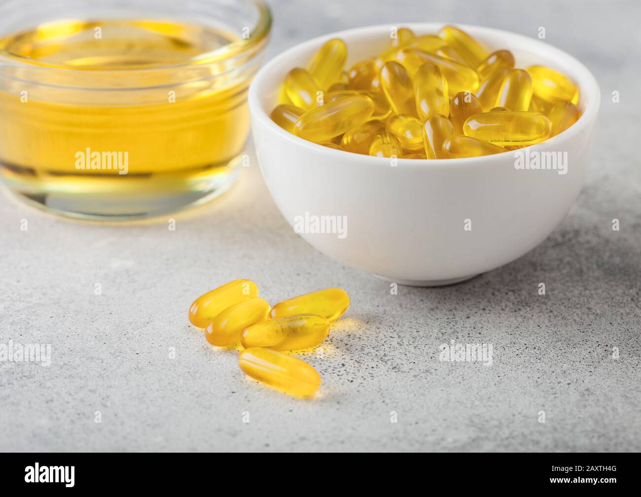 Bowl of raw natural organic linseed flaxseed oil and omega 3 capsules ...