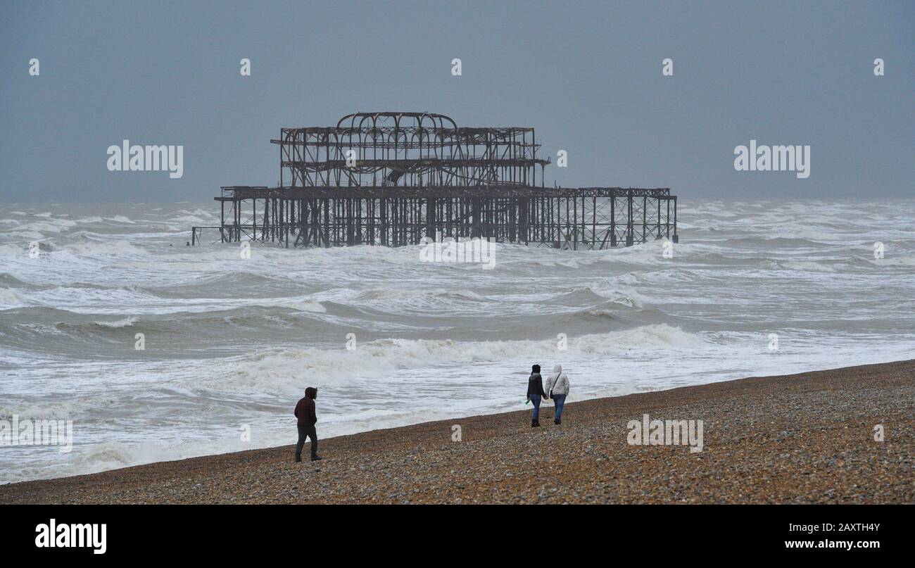 Brighton UK 13th February 2020 - Walkers brave the wet and windy ...