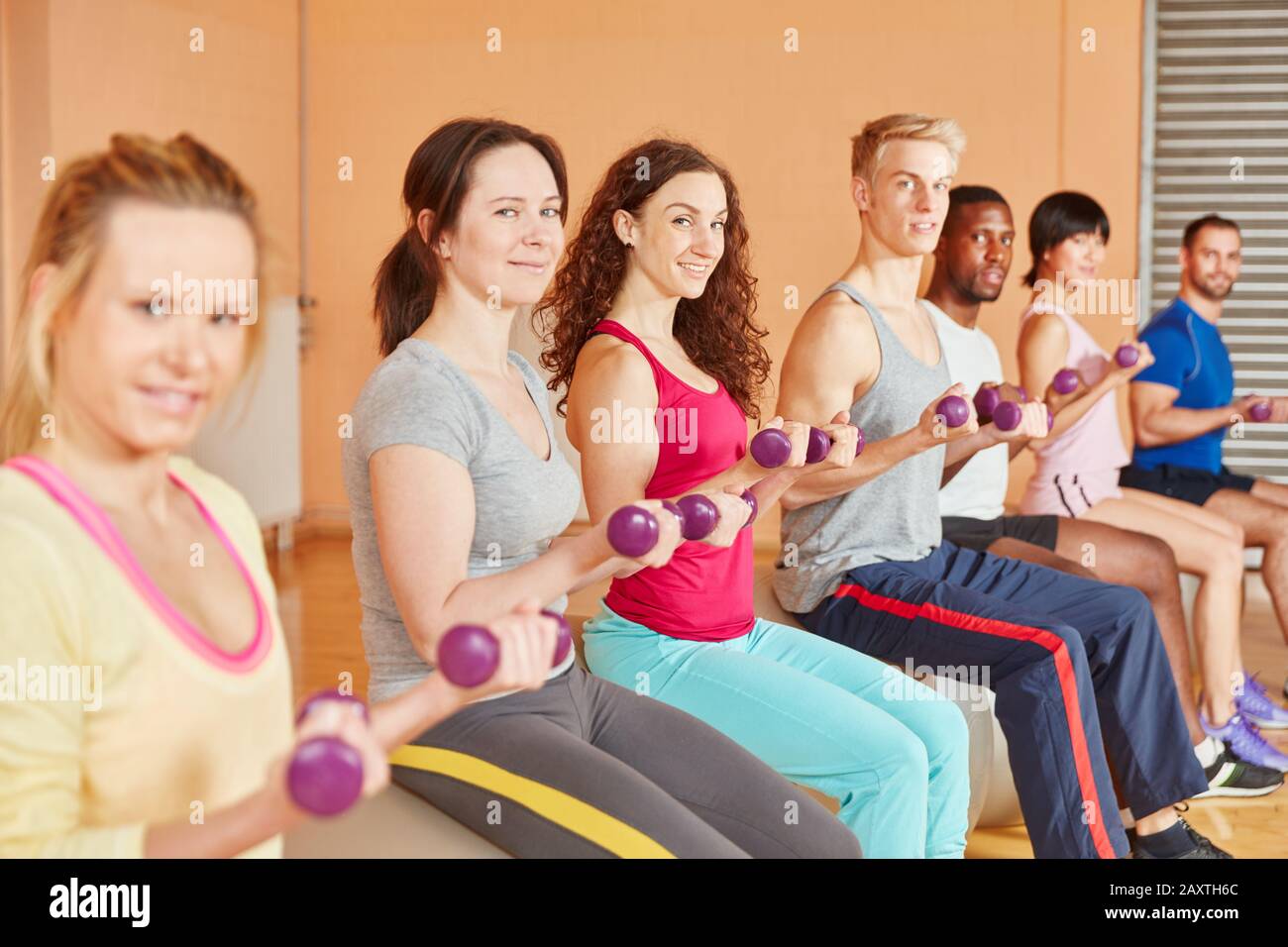 People lift weights with dumbbells in the fitness center Stock Photo ...
