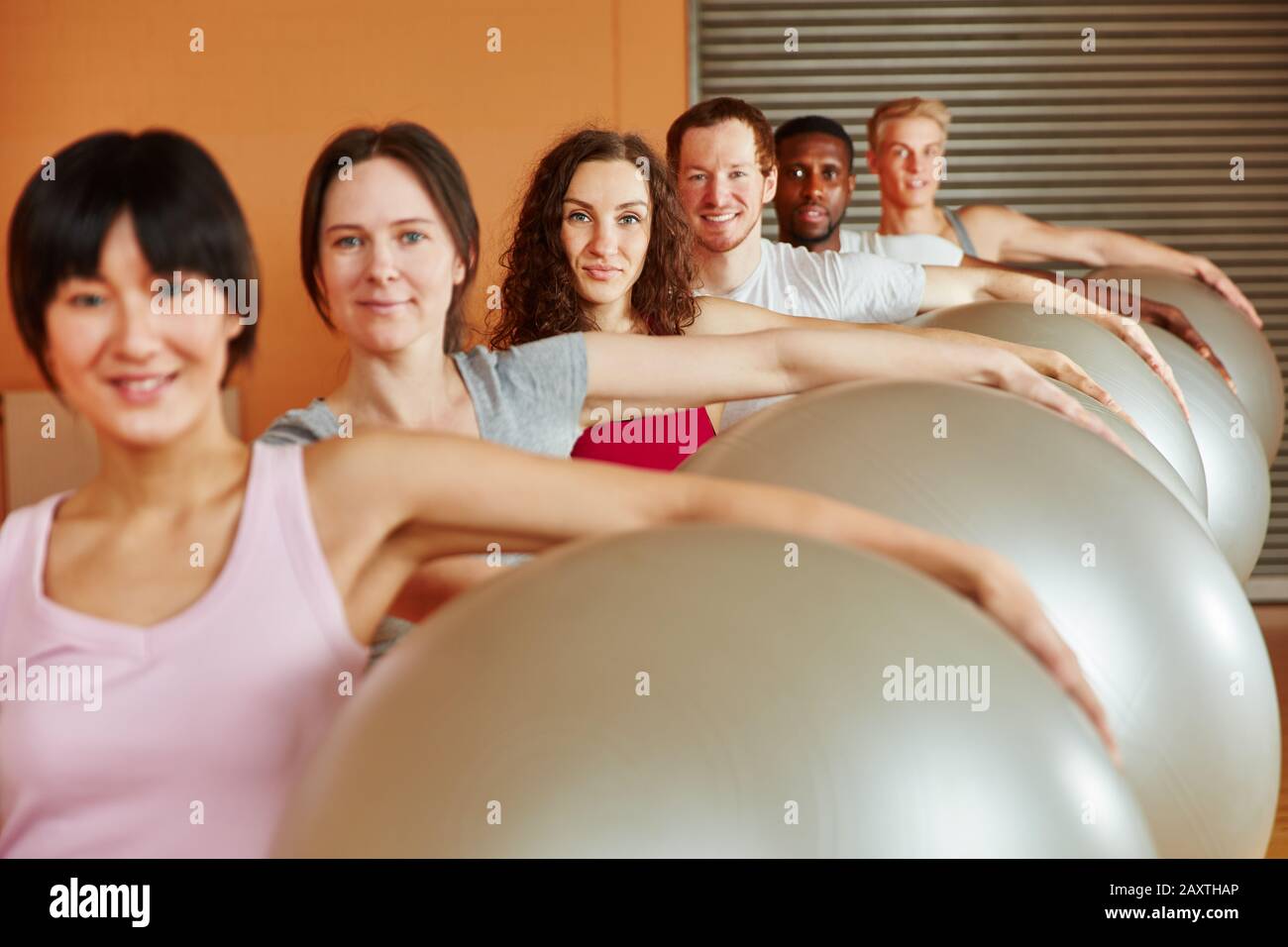 Group in fitness class doing exercise with exercise ball Stock Photo ...