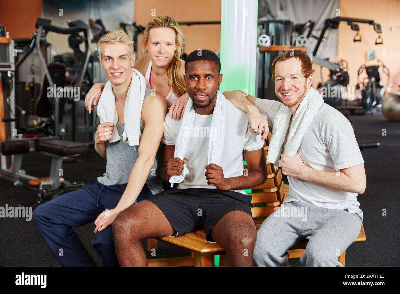 Happy friends take a break together after workout at the fitness center ...