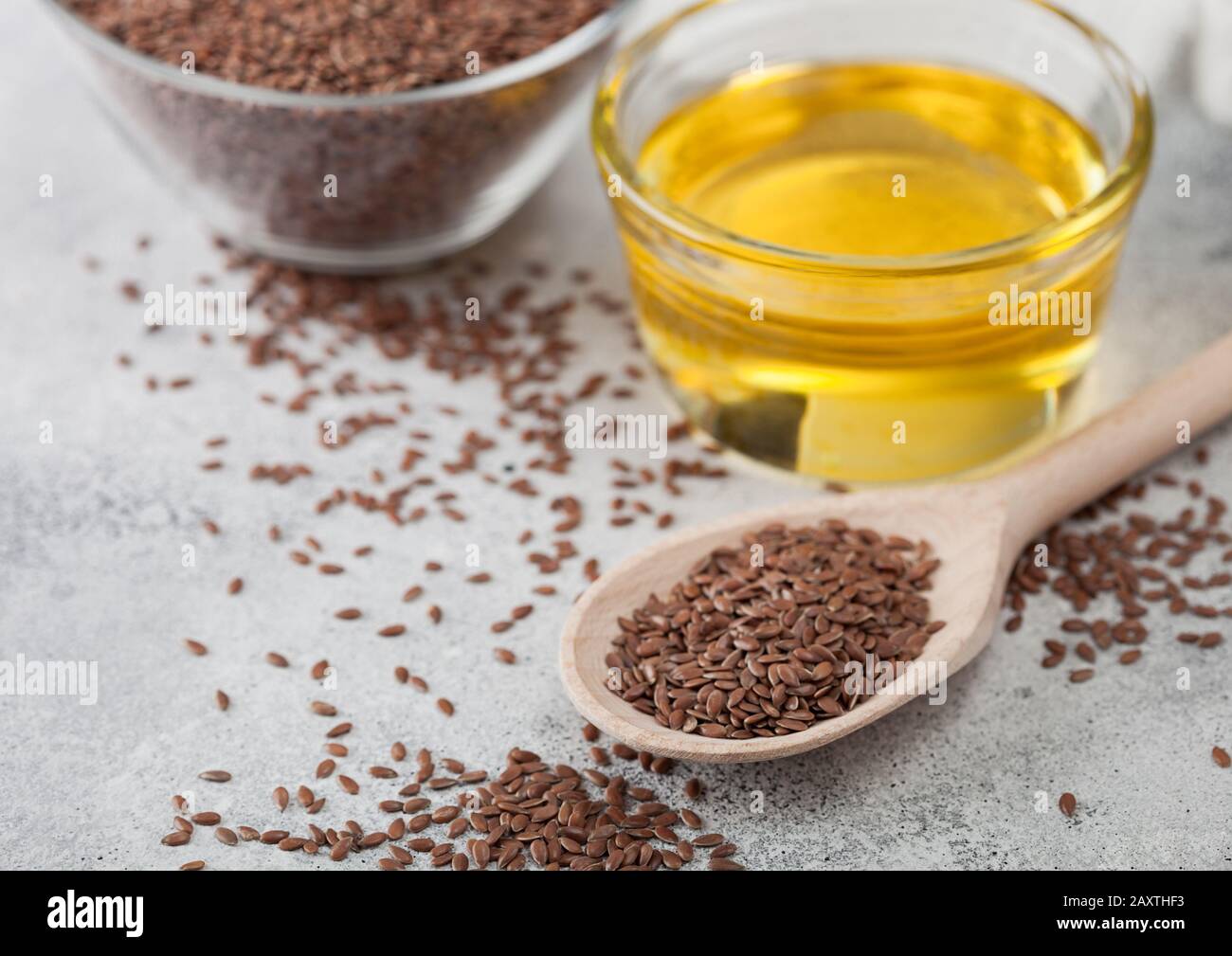 Bowl of raw natural organic linseed flax-seed with spoon and oil on ...