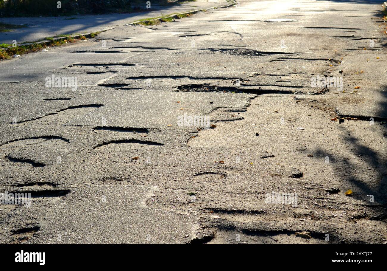 large pits on the road from asphalt roadway Stock Photo - Alamy