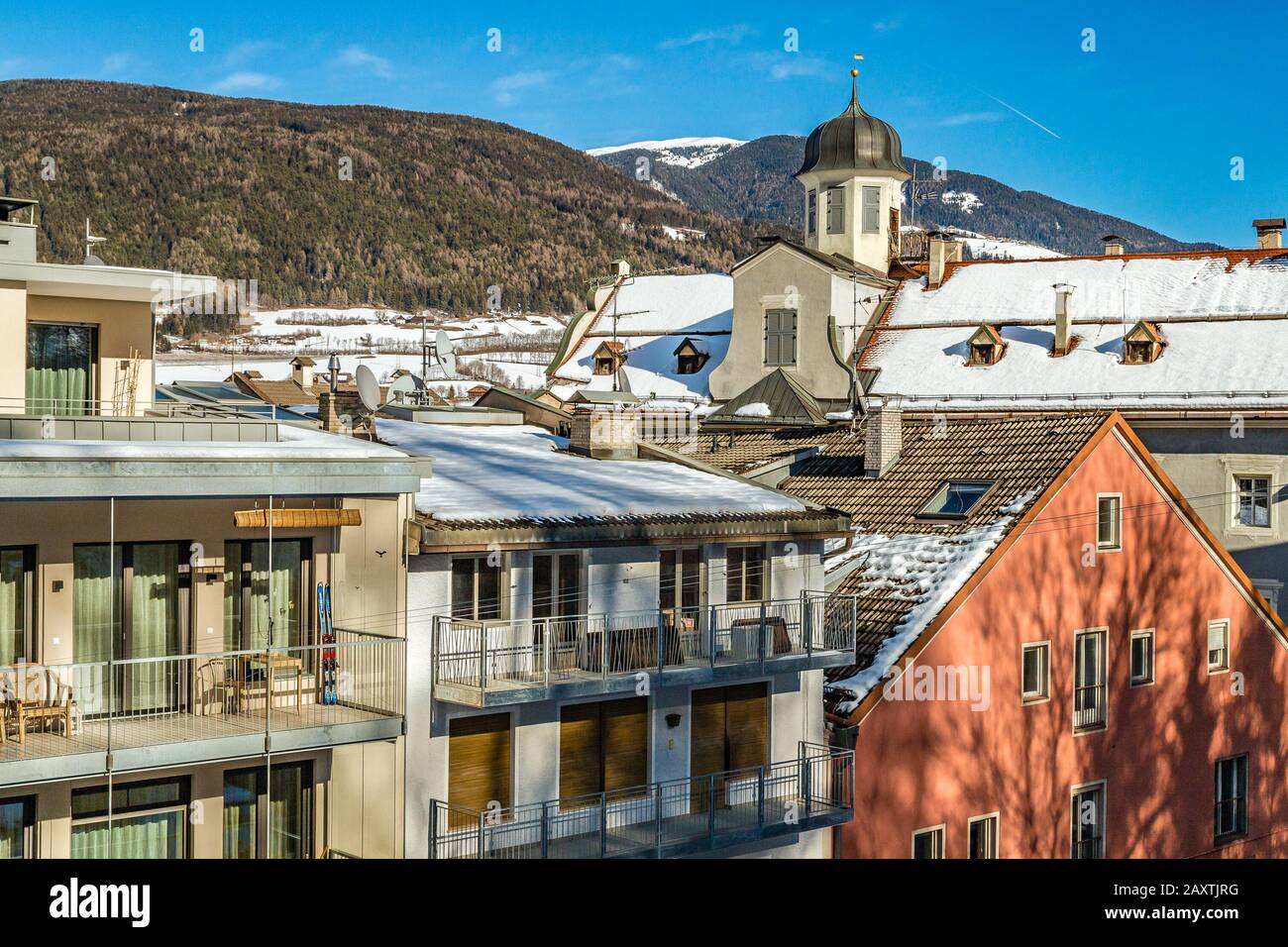 Brunico (BZ), February 12, 2019: sunlight is enlightening a building of ... Brunico (BZ), February 12, 2019: sunlight is enlightening a building of ...