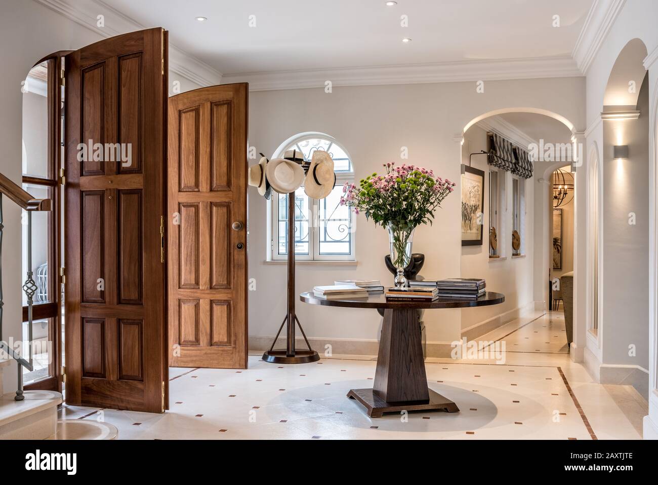 Open wooden doors to entrance hall Stock Photo - Alamy