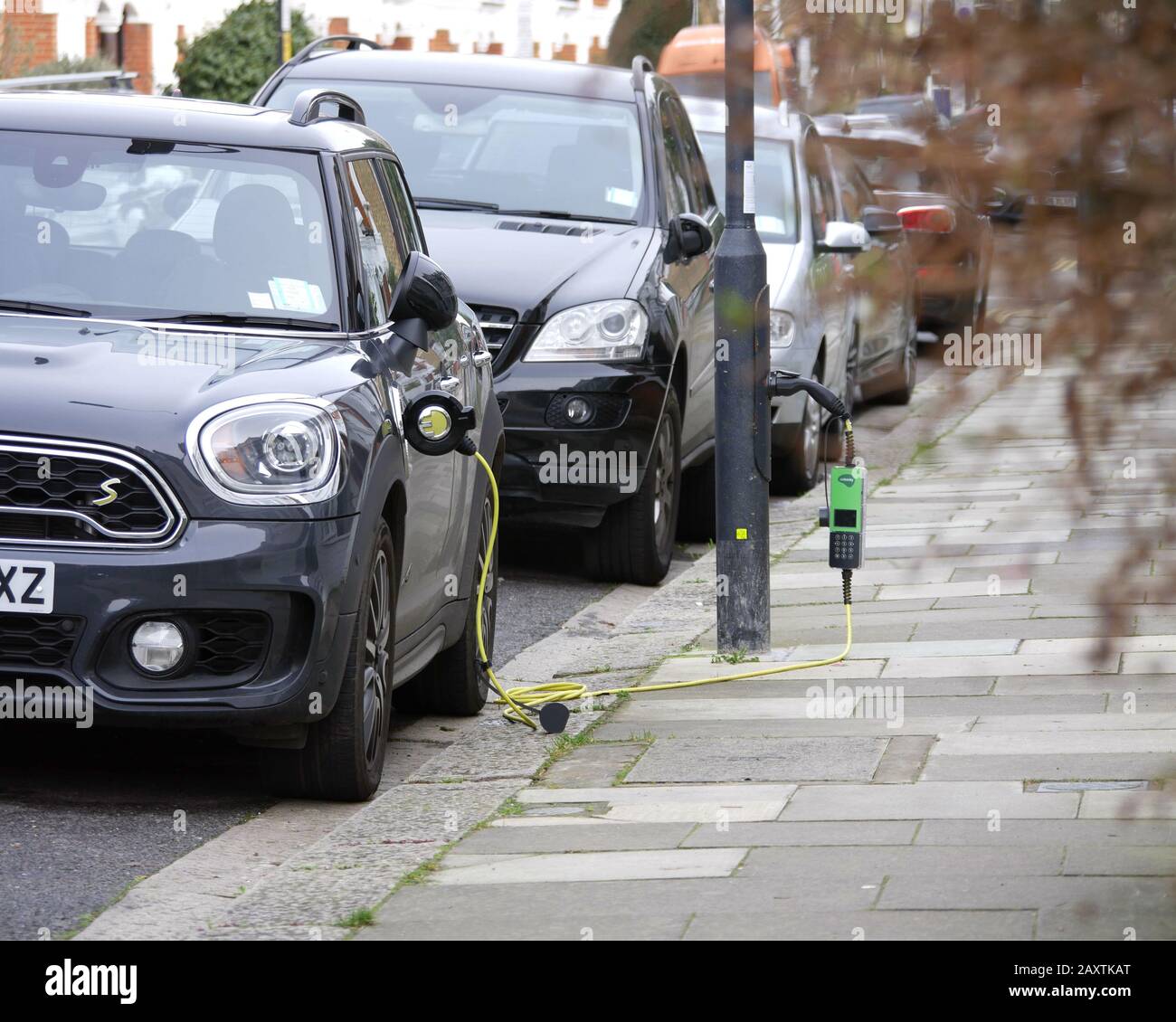 Mini Metro electric car being charged from a lamp post on a street in ...
