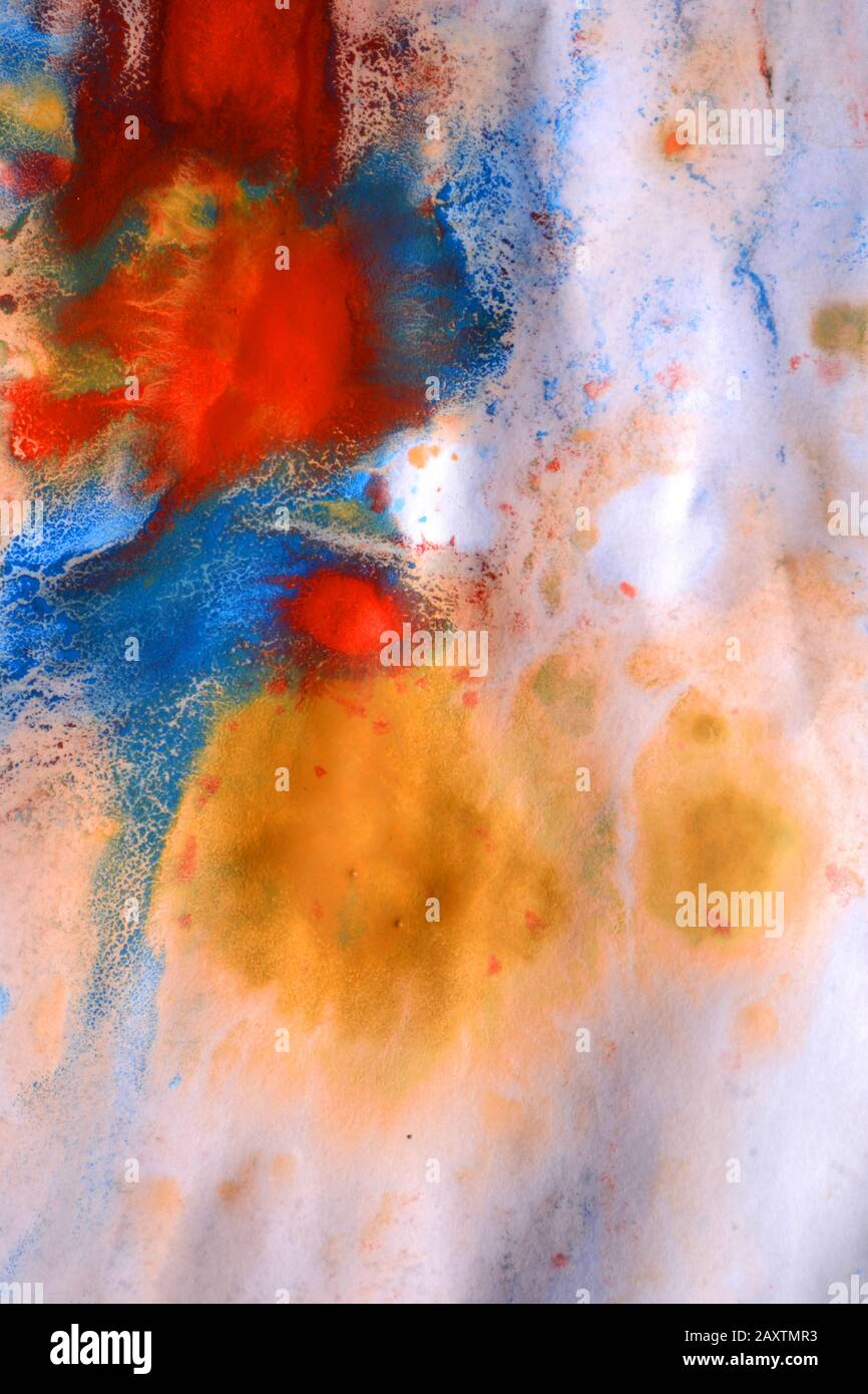 Drops with streaks of different colors of paint are mixed and absorbed ...