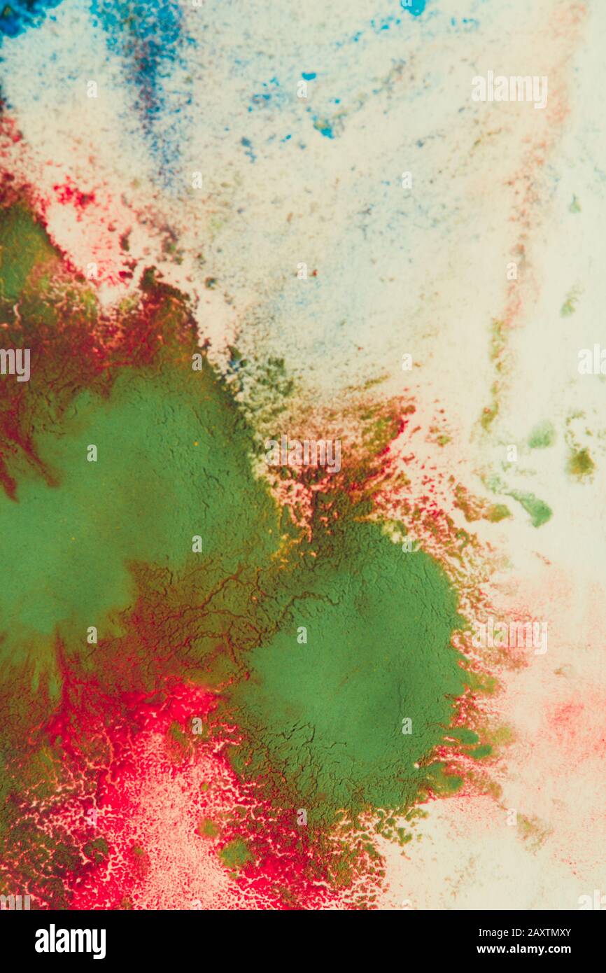 Mixing of paints of different colors on a white paper. Abstract ...