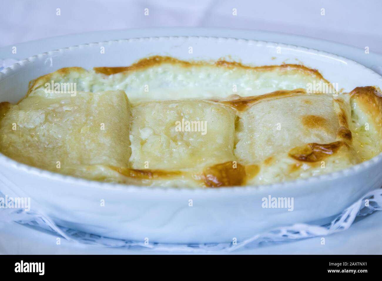 Closeup shot of a delicious croatian cheese pie placed on a white plate ...